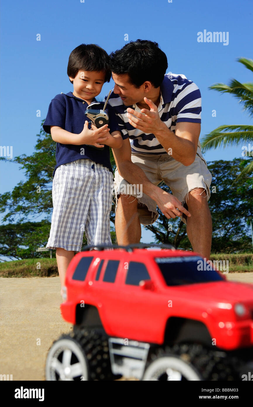 Father and son at the beach with remote controlled toy Stock Photo - Alamy