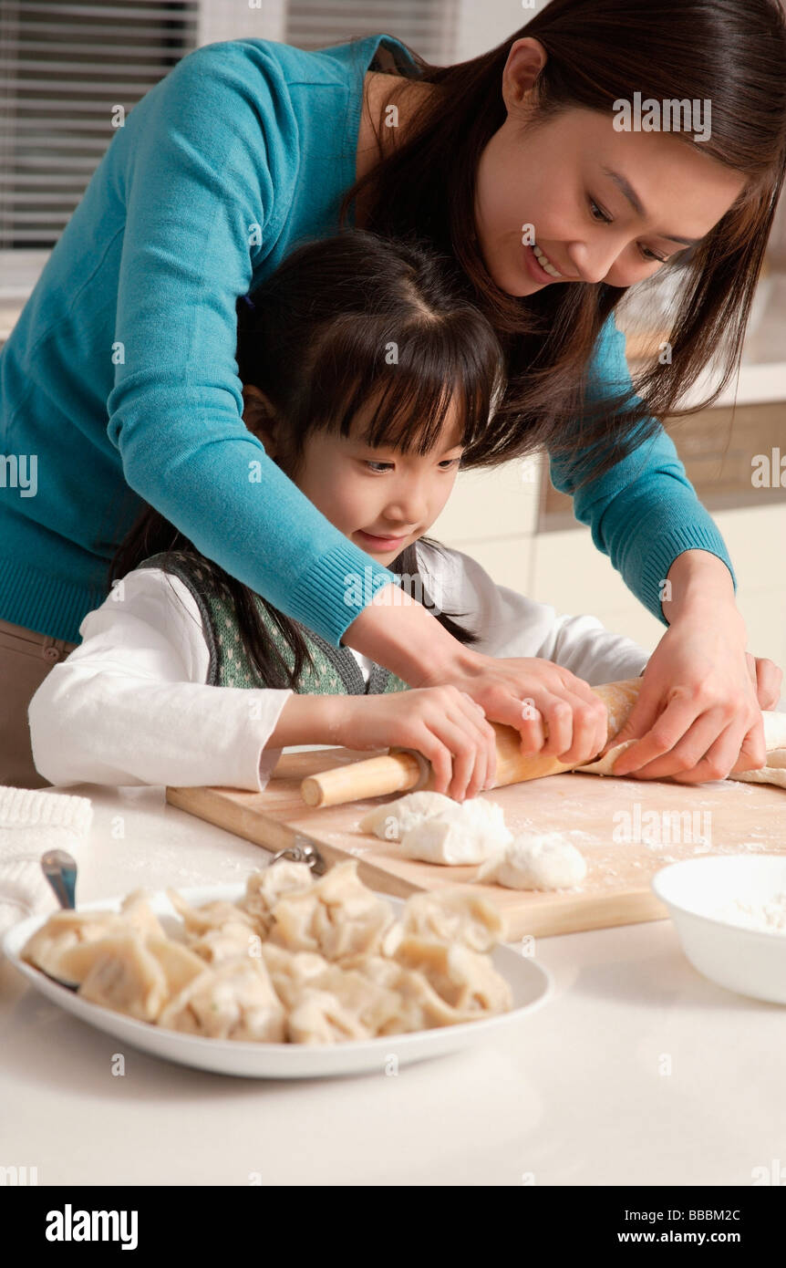 Mother and daughter making dumplings in the kitchen Stock Photo - Alamy
