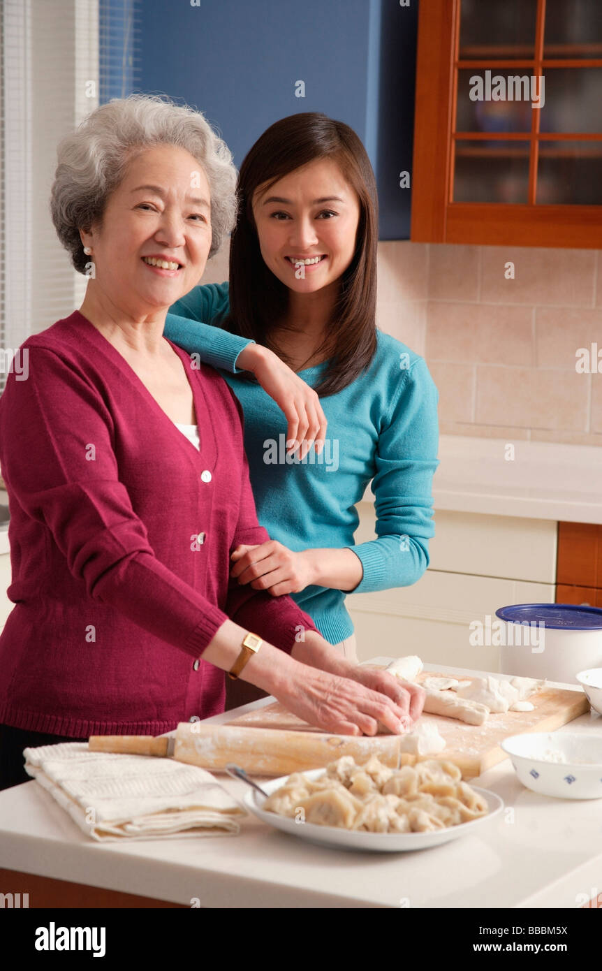 Mother and daughter making dumplings in the kitchen Stock Photo - Alamy