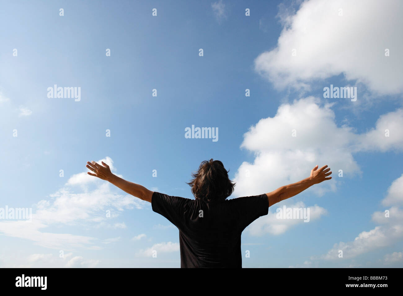 Man looking at the sky, arms outstretched Stock Photo - Alamy