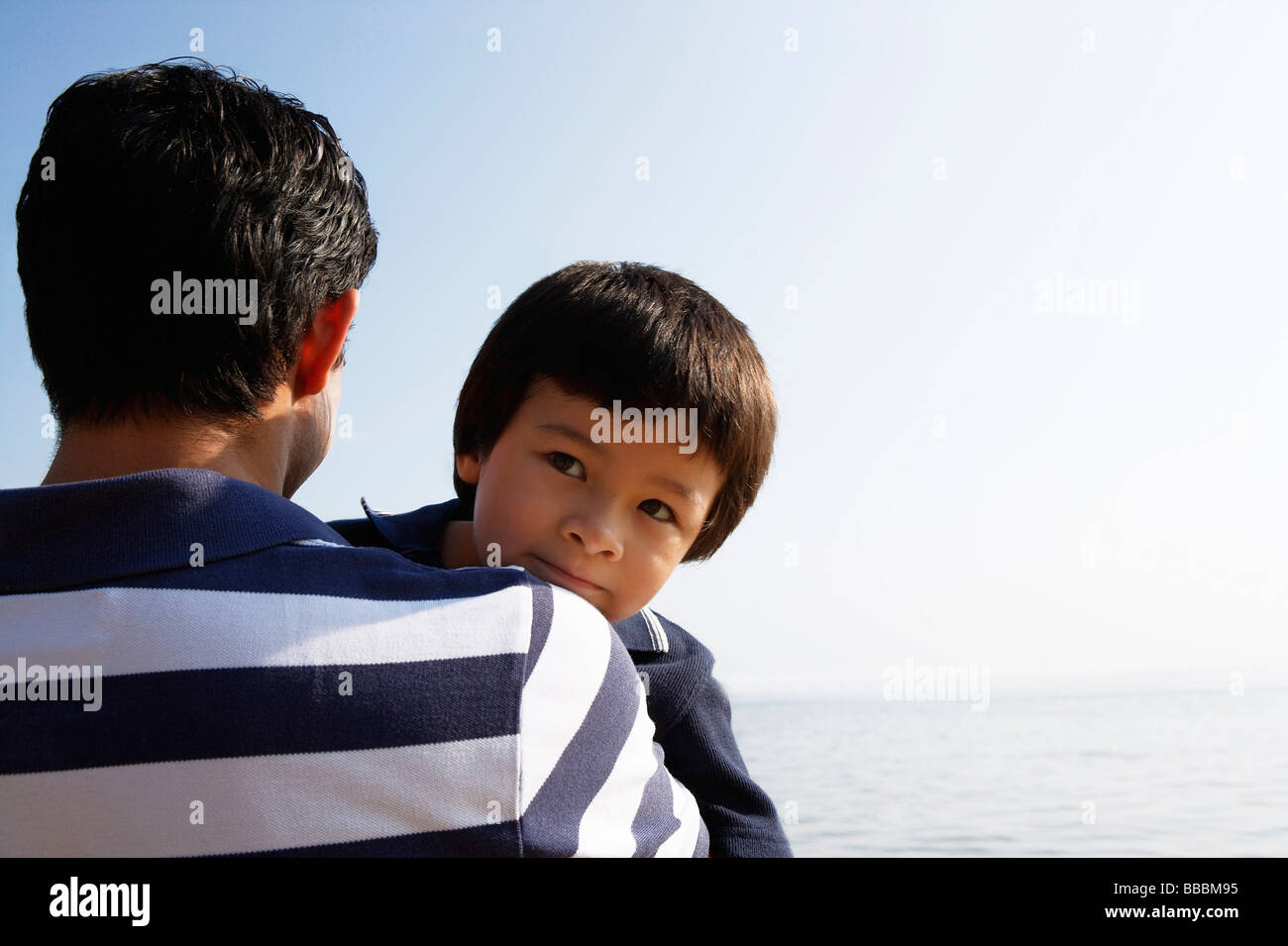Father carrying son Stock Photo - Alamy