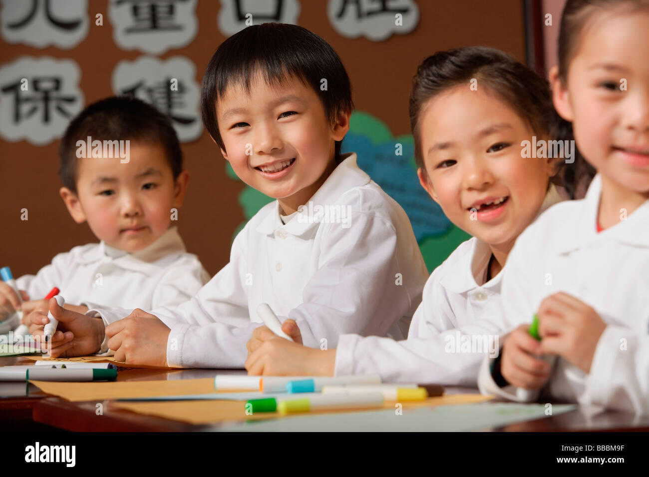Students in class smiling at camera Stock Photo - Alamy