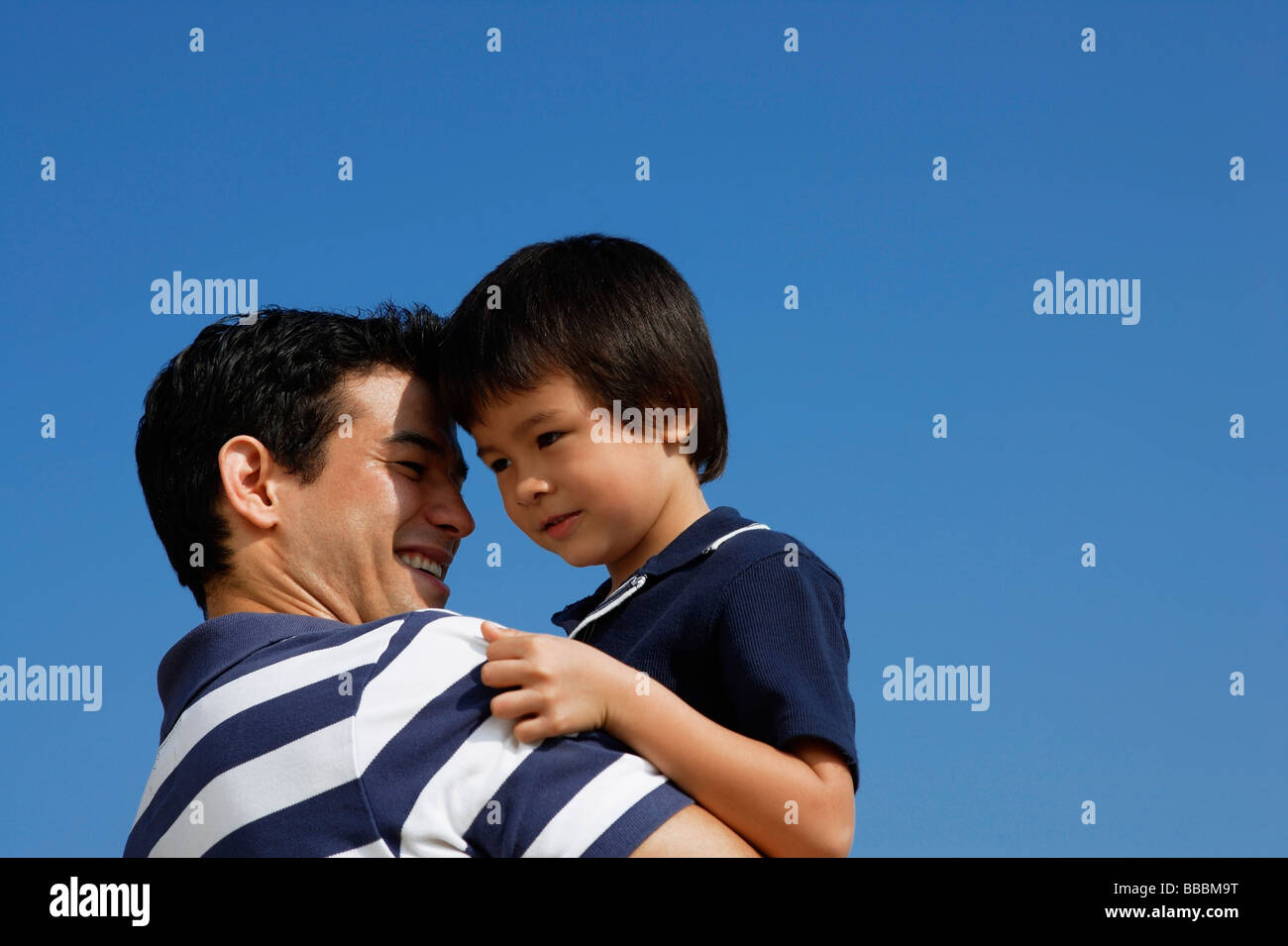 Father carrying son Stock Photo - Alamy