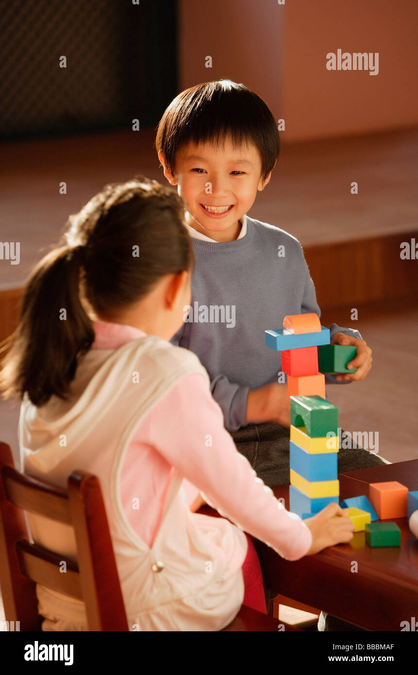 Young children playing with building blocks Stock Photo - Alamy