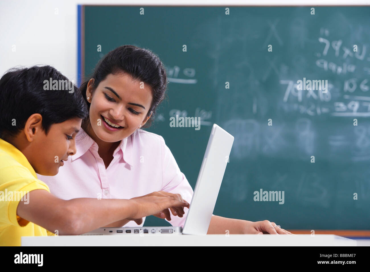 teacher working with student at laptop Stock Photo - Alamy