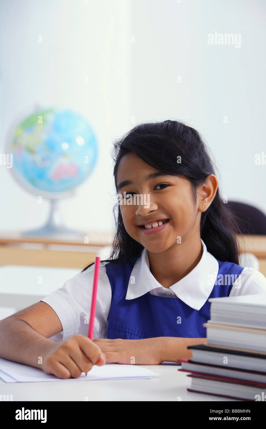 girl at desk with red pencil (vertical Stock Photo - Alamy