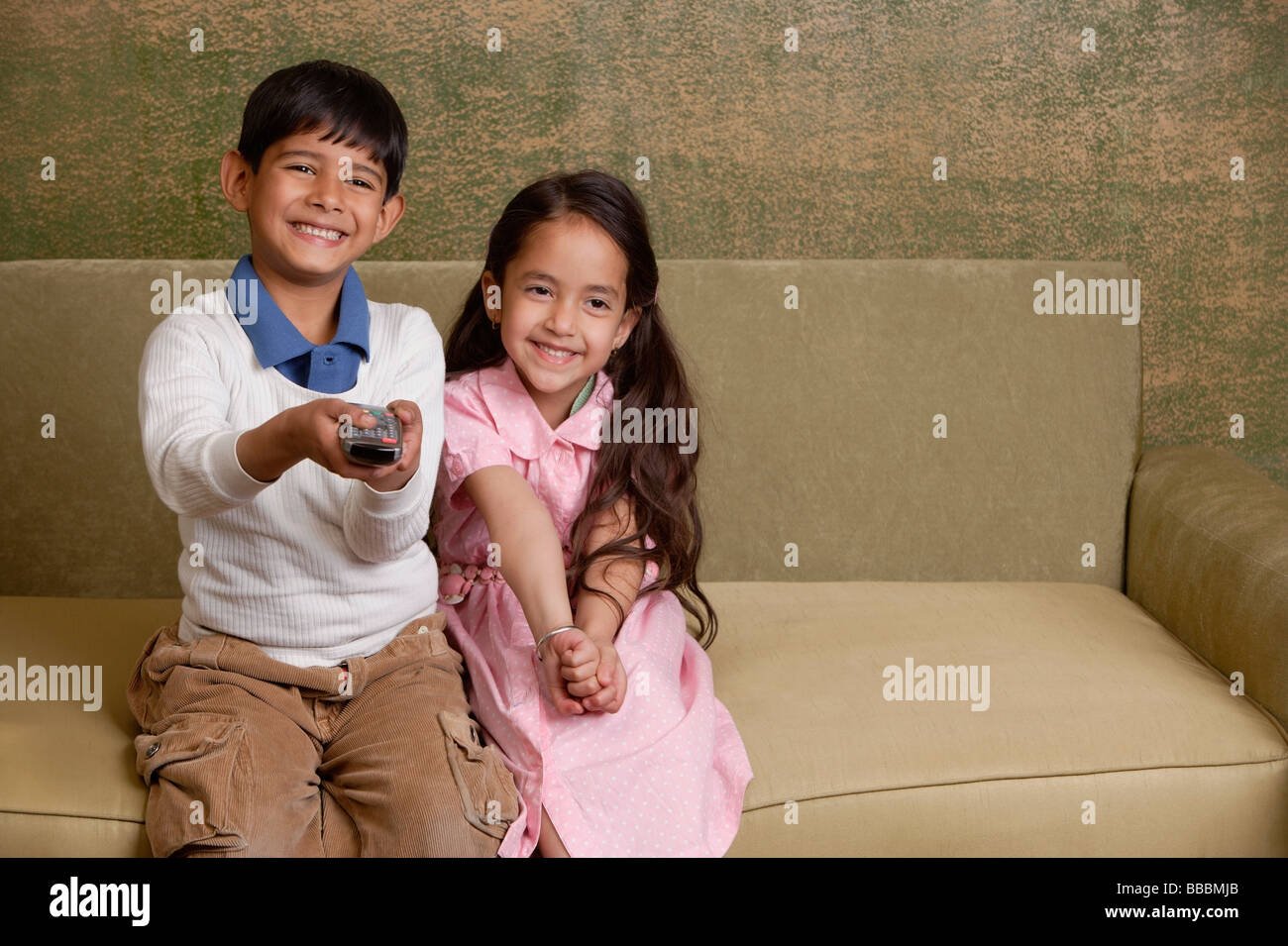Happy girl holding remote hi-res stock photography and images - Alamy