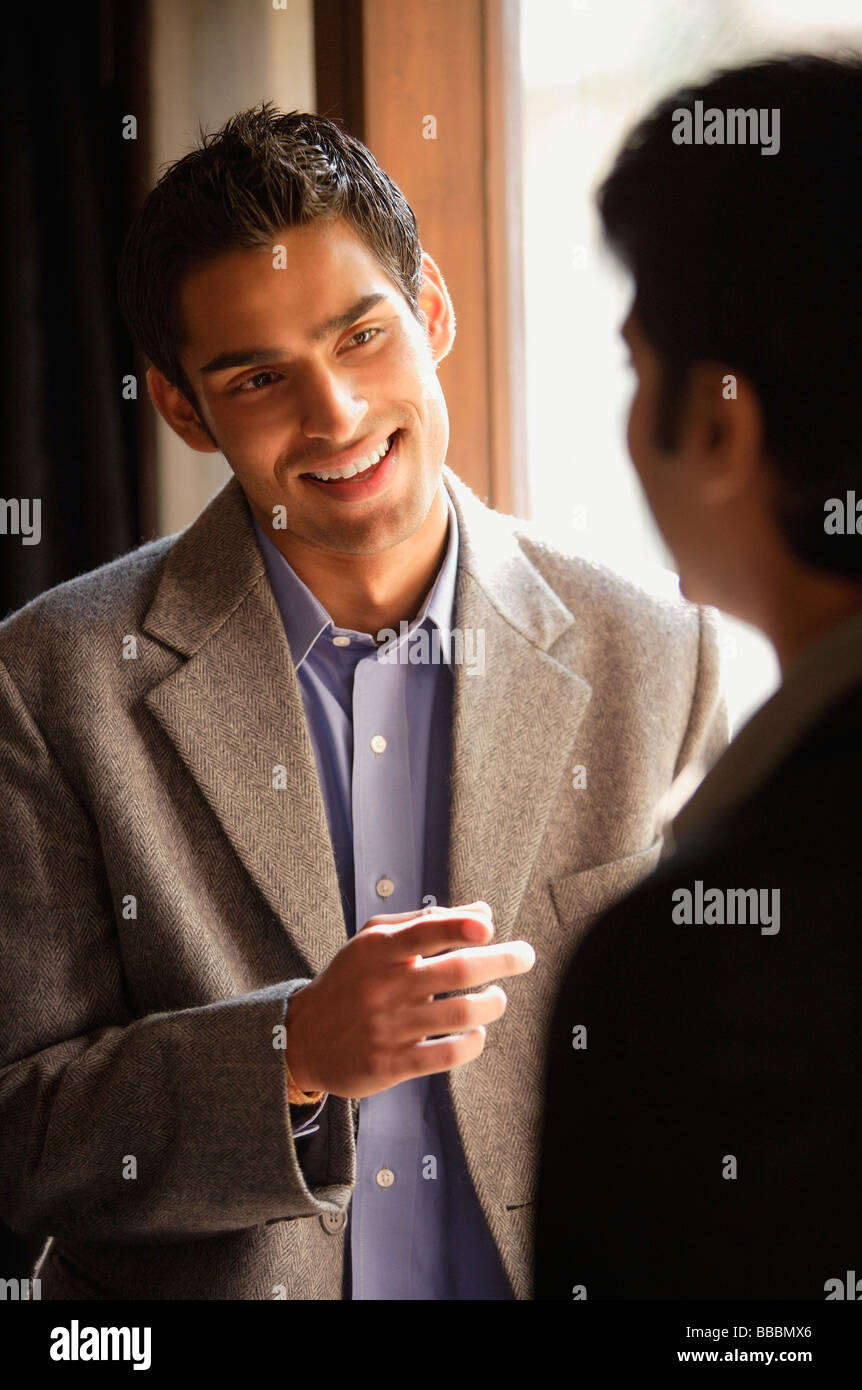 two male colleagues talking (vertical Stock Photo - Alamy