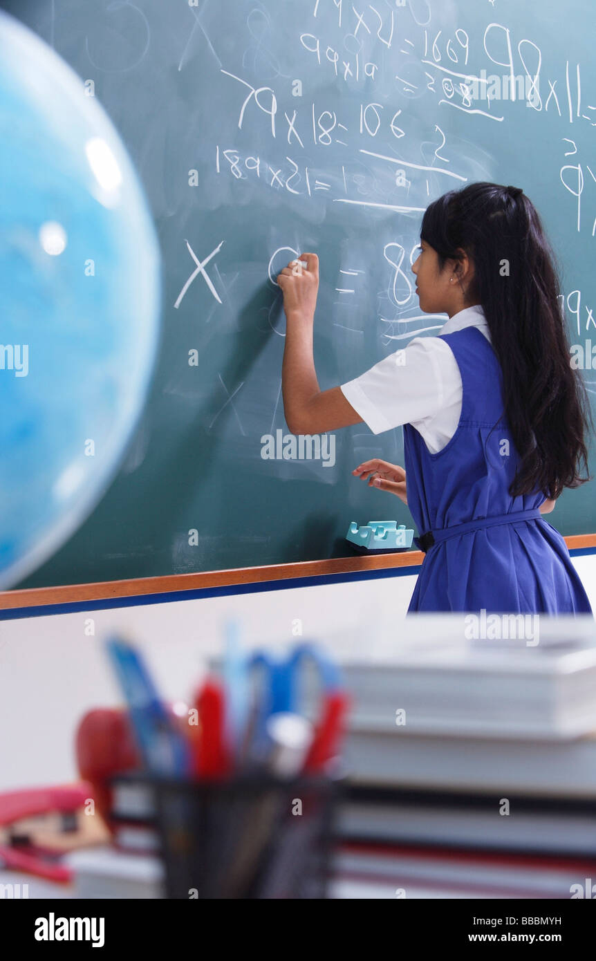 girl working at chalkboard (vertical Stock Photo - Alamy