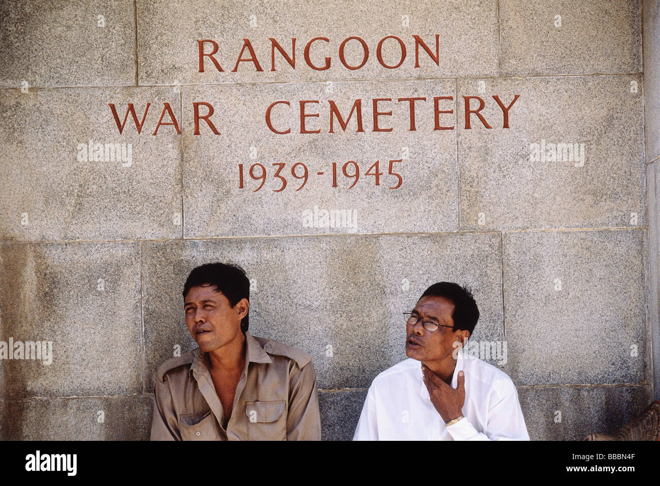 Myanmar (Burma), Yangon (Rangoon), Men sitting by one of the signs in ...