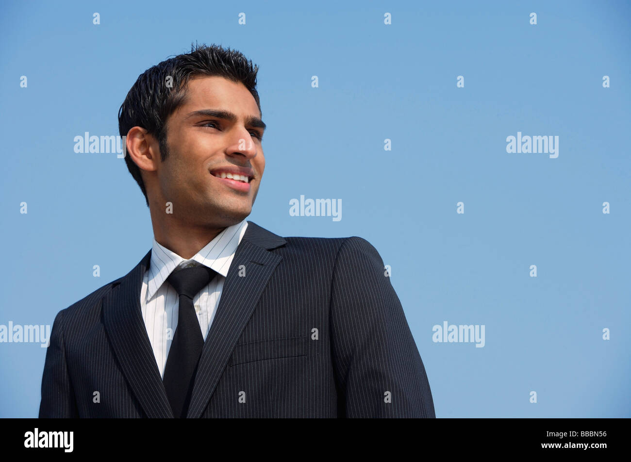 businessman smiles, looks back Stock Photo - Alamy