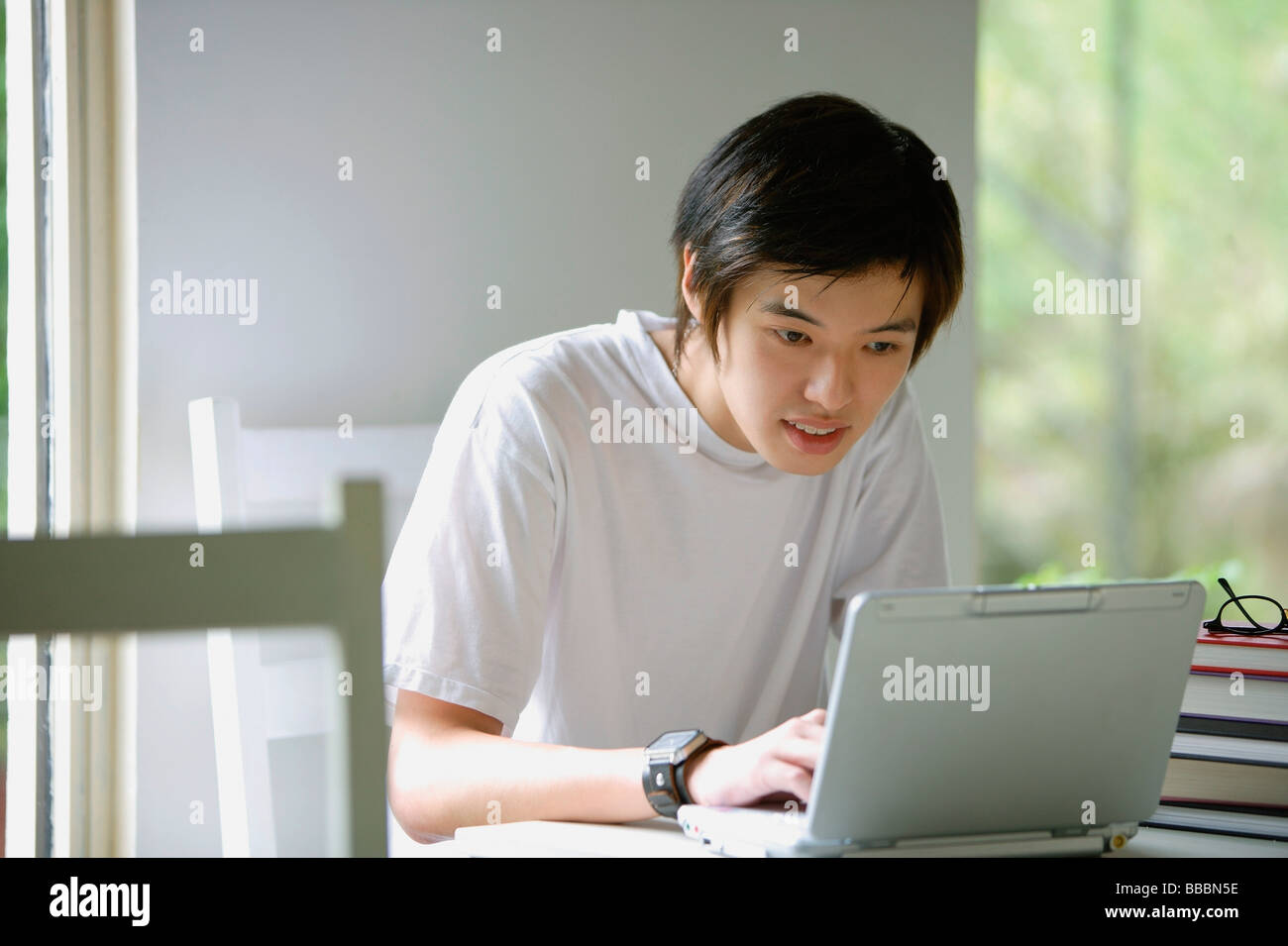 Young man using laptop Stock Photo - Alamy