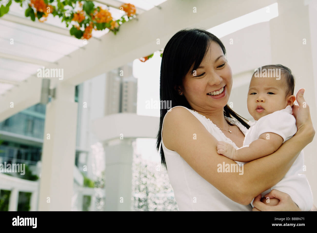 Mother carrying baby girl Stock Photo - Alamy Mother carrying baby girl Stock Photo - Alamy