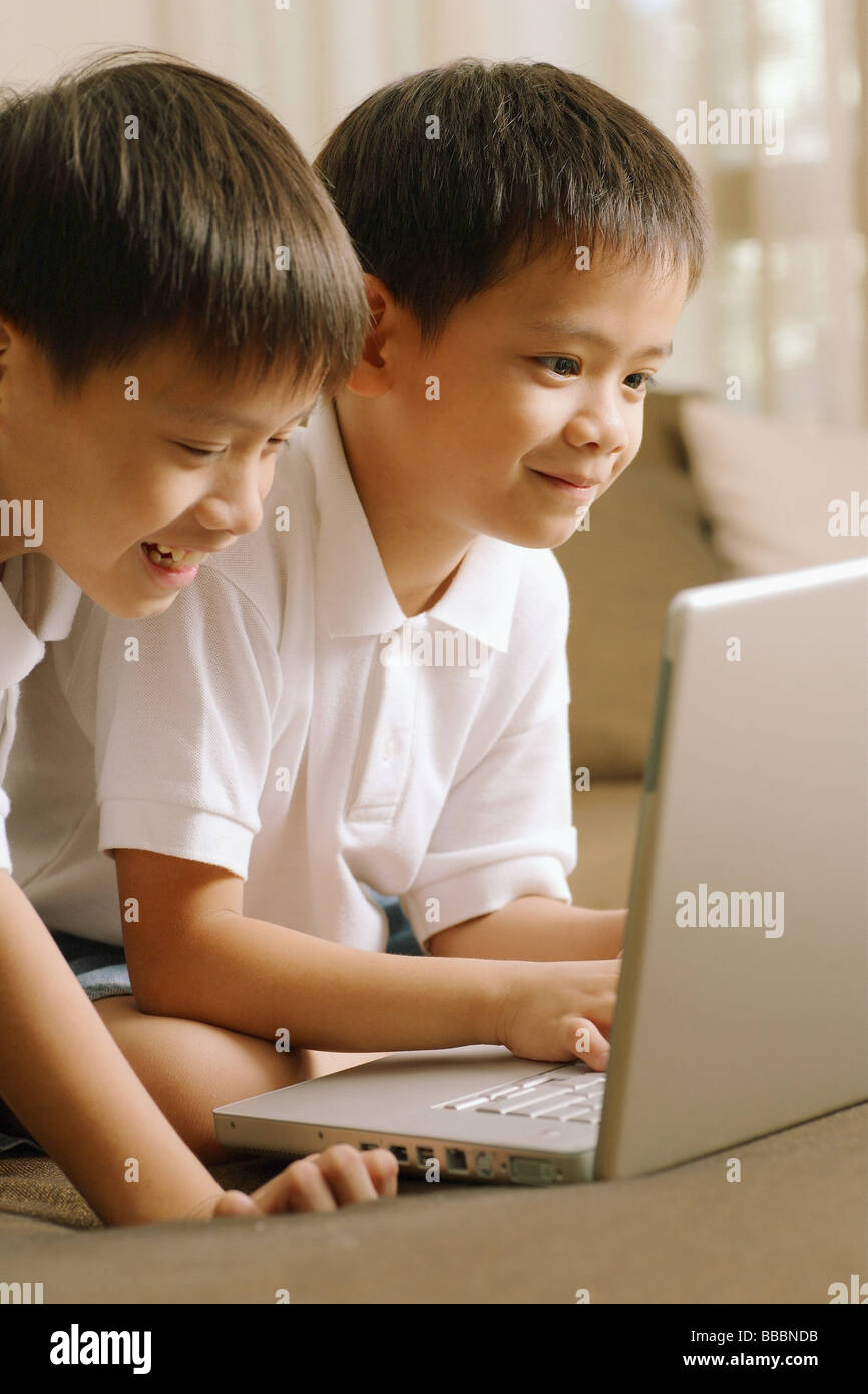 Two children using laptop Stock Photo - Alamy