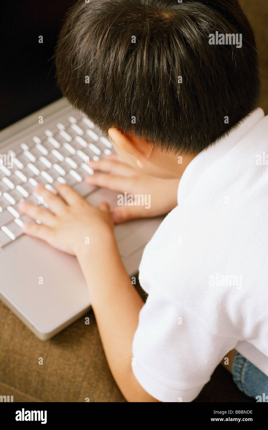Young boy using laptop Stock Photo - Alamy