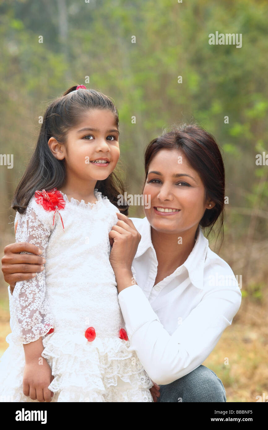Mother with arms around daughter Stock Photo - Alamy