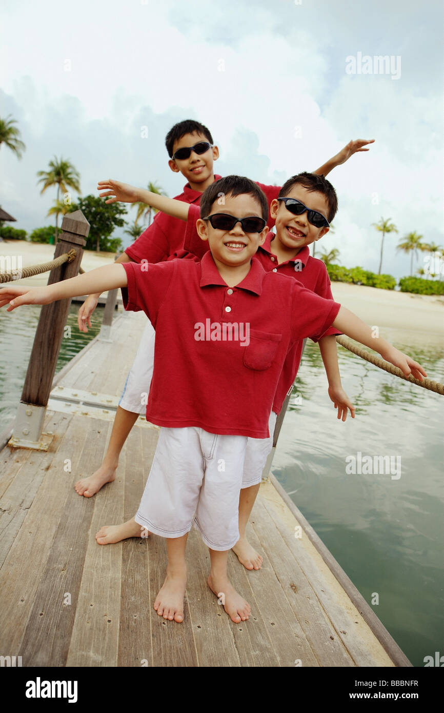 Three boys standing in a row hi-res stock photography and images - Alamy