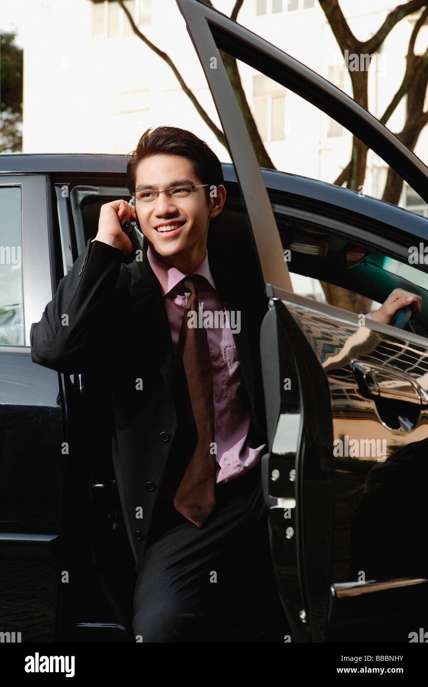 Young businessman getting out car hi-res stock photography and images ...