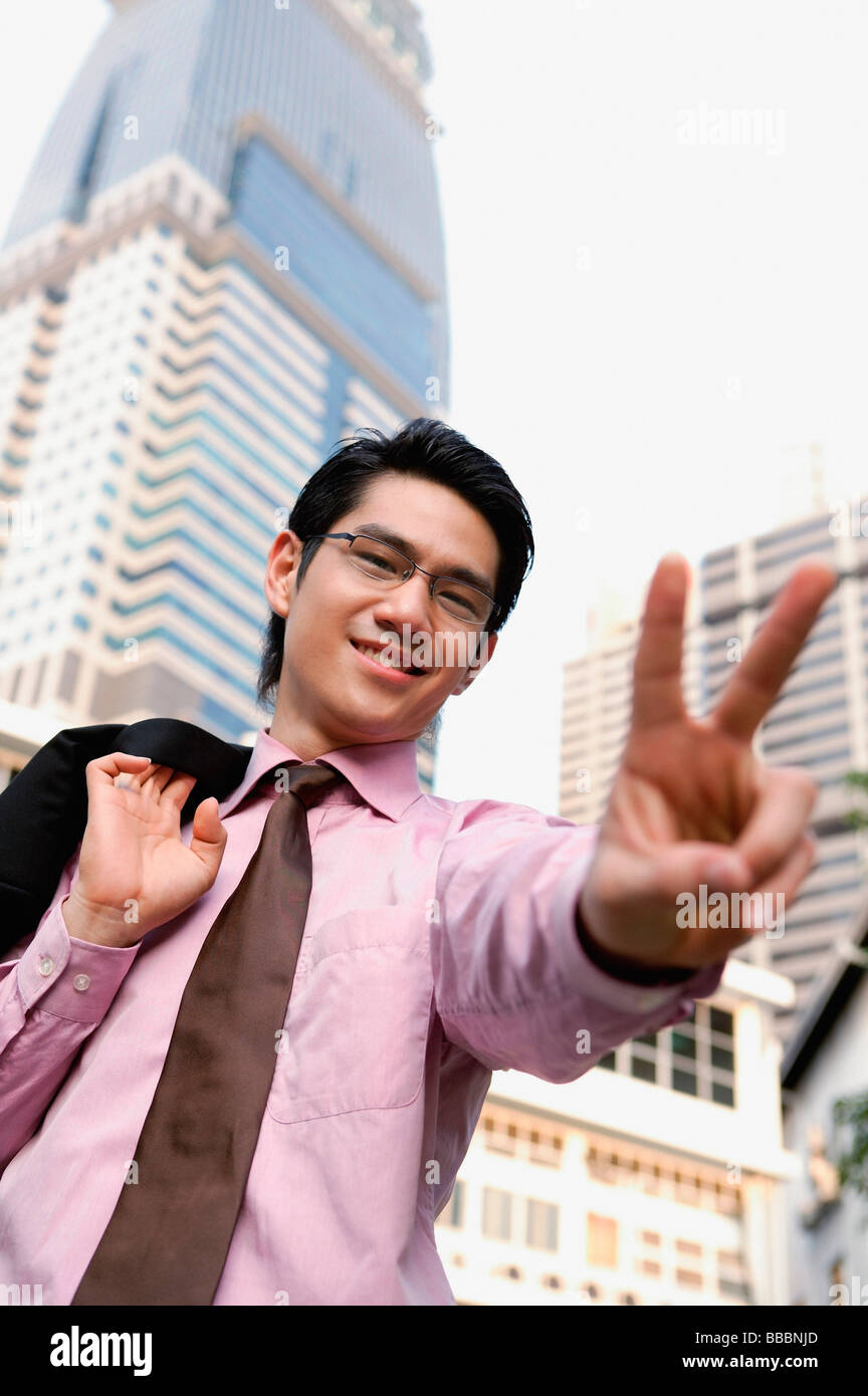 Businessman making hand sign Stock Photo - Alamy