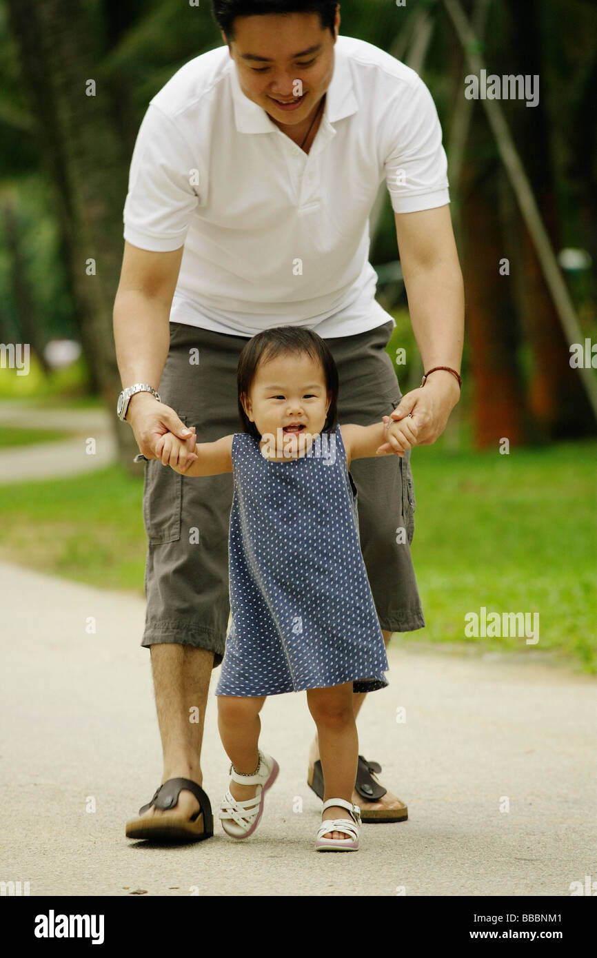 Father walking with daughter Stock Photo - Alamy