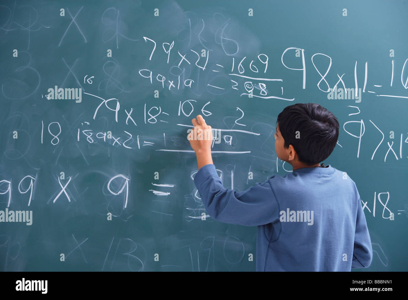 boy working at chalkboard (back view Stock Photo - Alamy