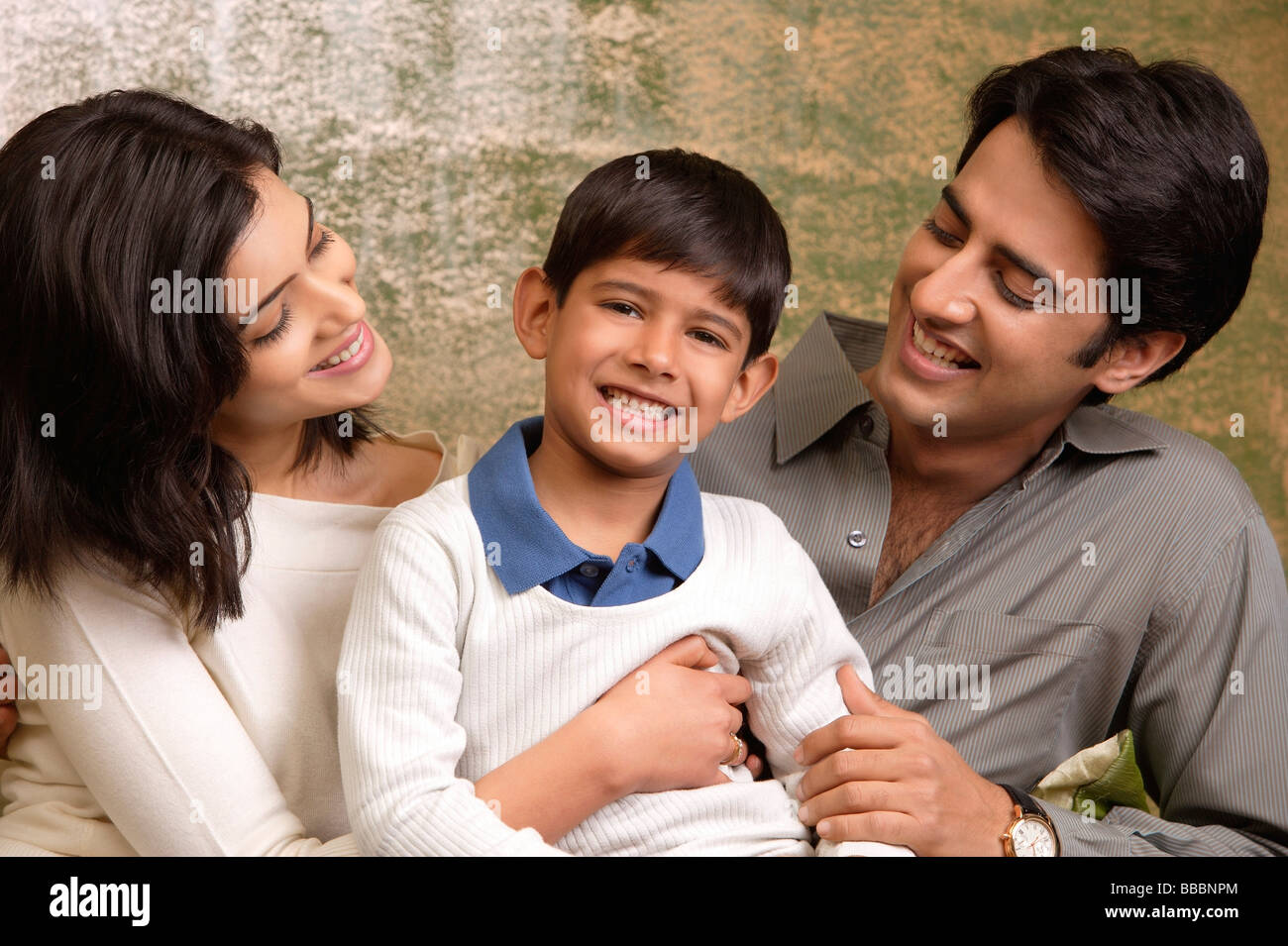 parents smile proudly at their son, son smiles at camera Stock Photo ...