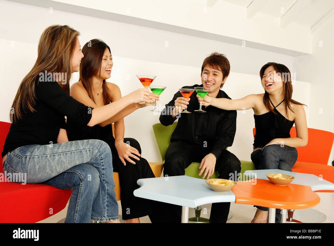 Young adults sitting in night club hi-res stock photography and images ...