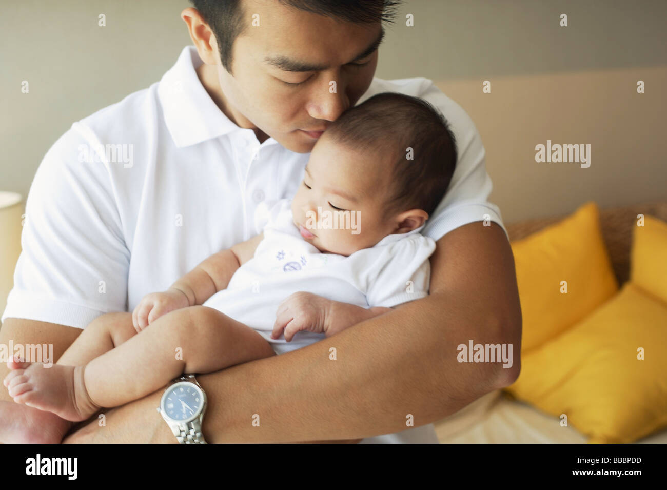 Father carrying baby daughter, portrait Stock Photo - Alamy