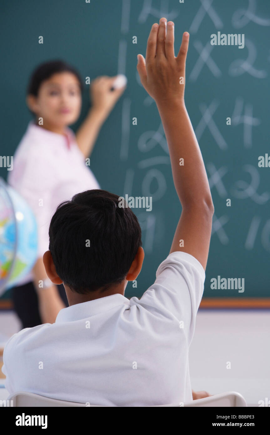 boy raises hand (back view Stock Photo - Alamy