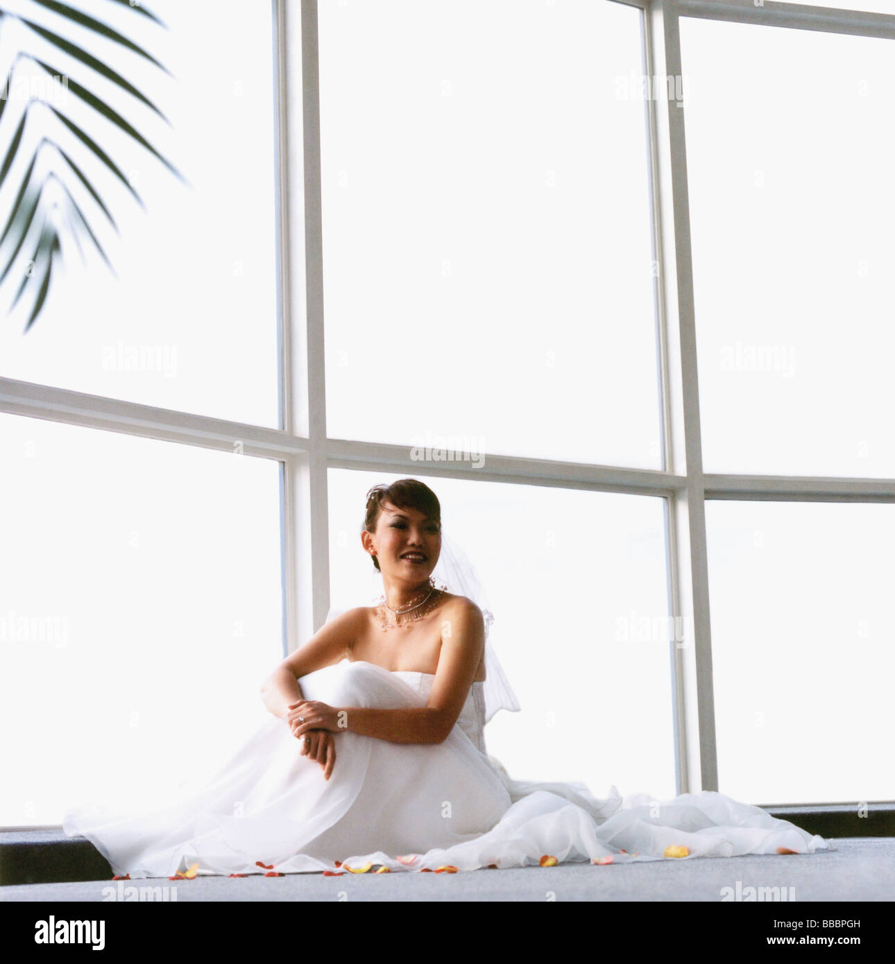 Bride sitting on floor, smiling Stock Photo - Alamy