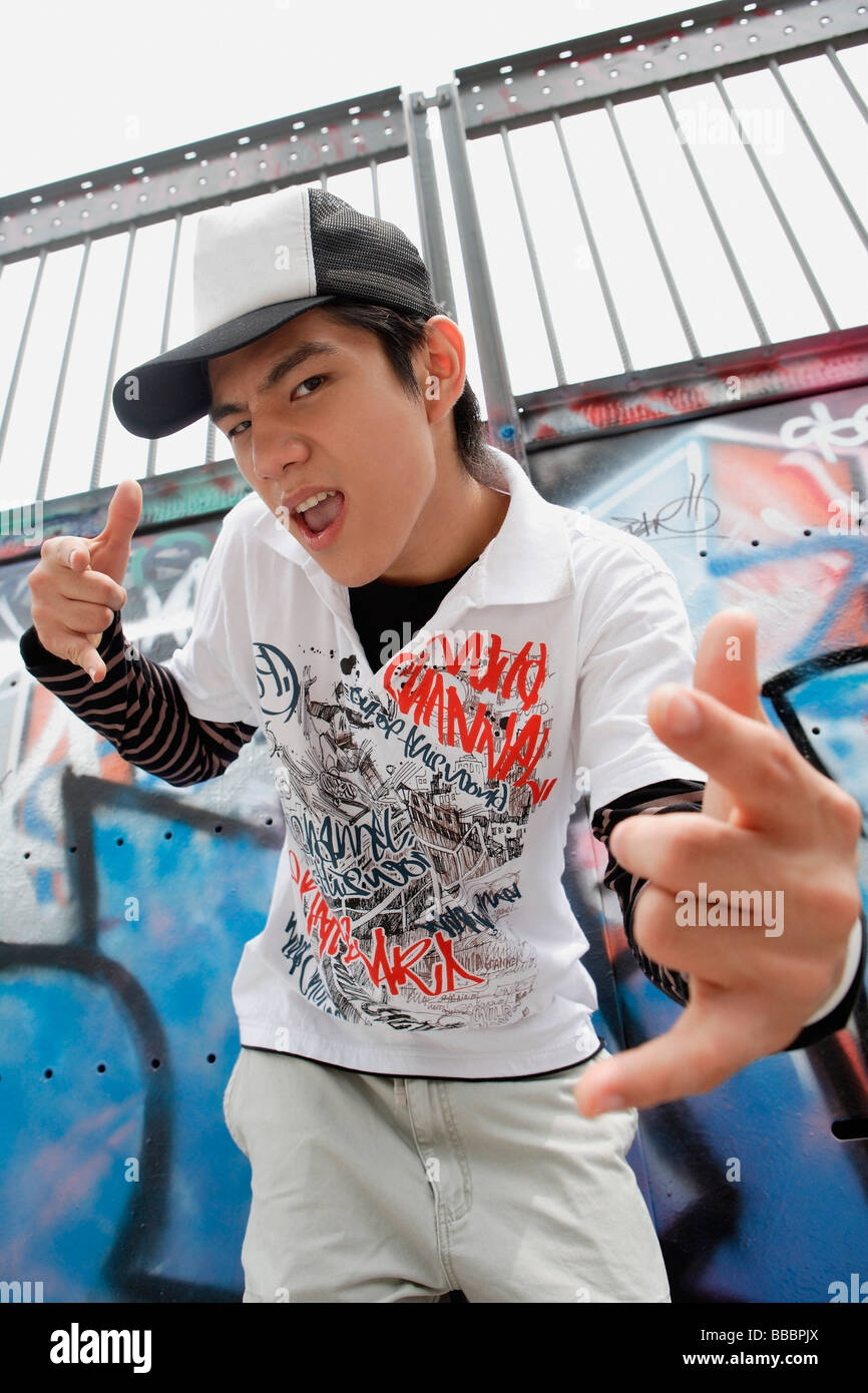 Young man making hand sign at camera Stock Photo - Alamy