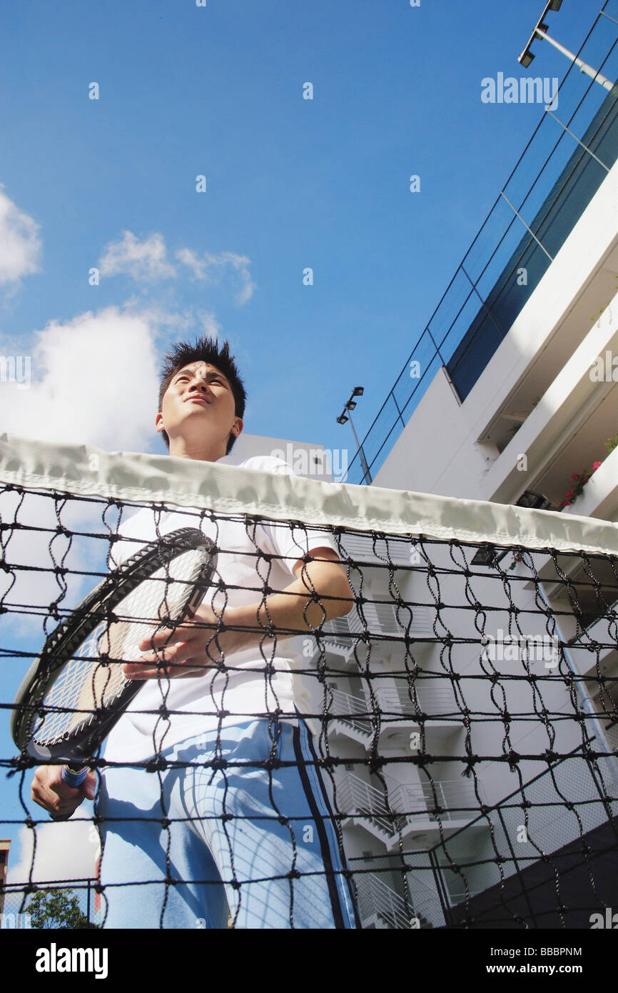 Man holding tennis racket Stock Photo - Alamy
