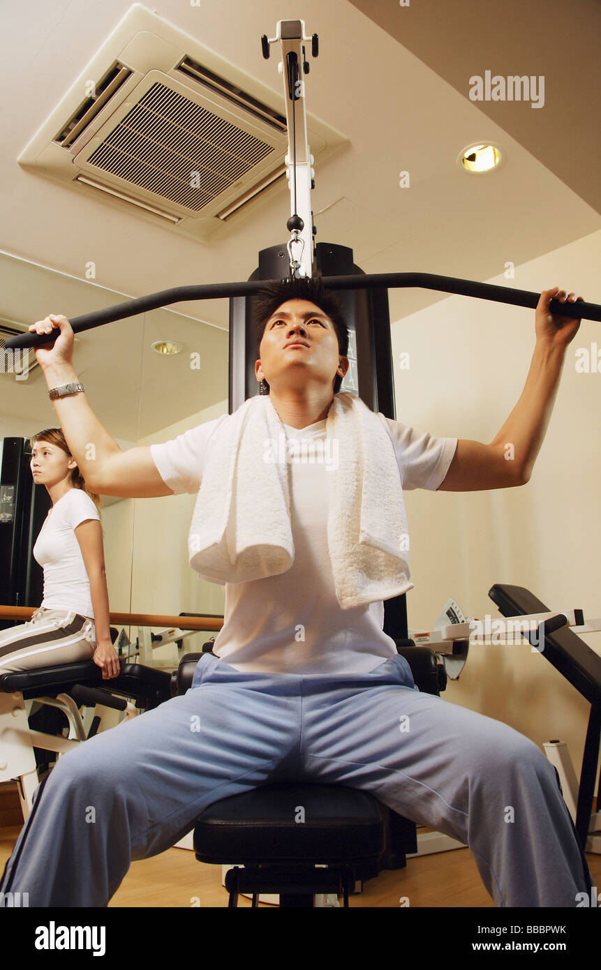 Man using exercise machine, low angle view Stock Photo - Alamy