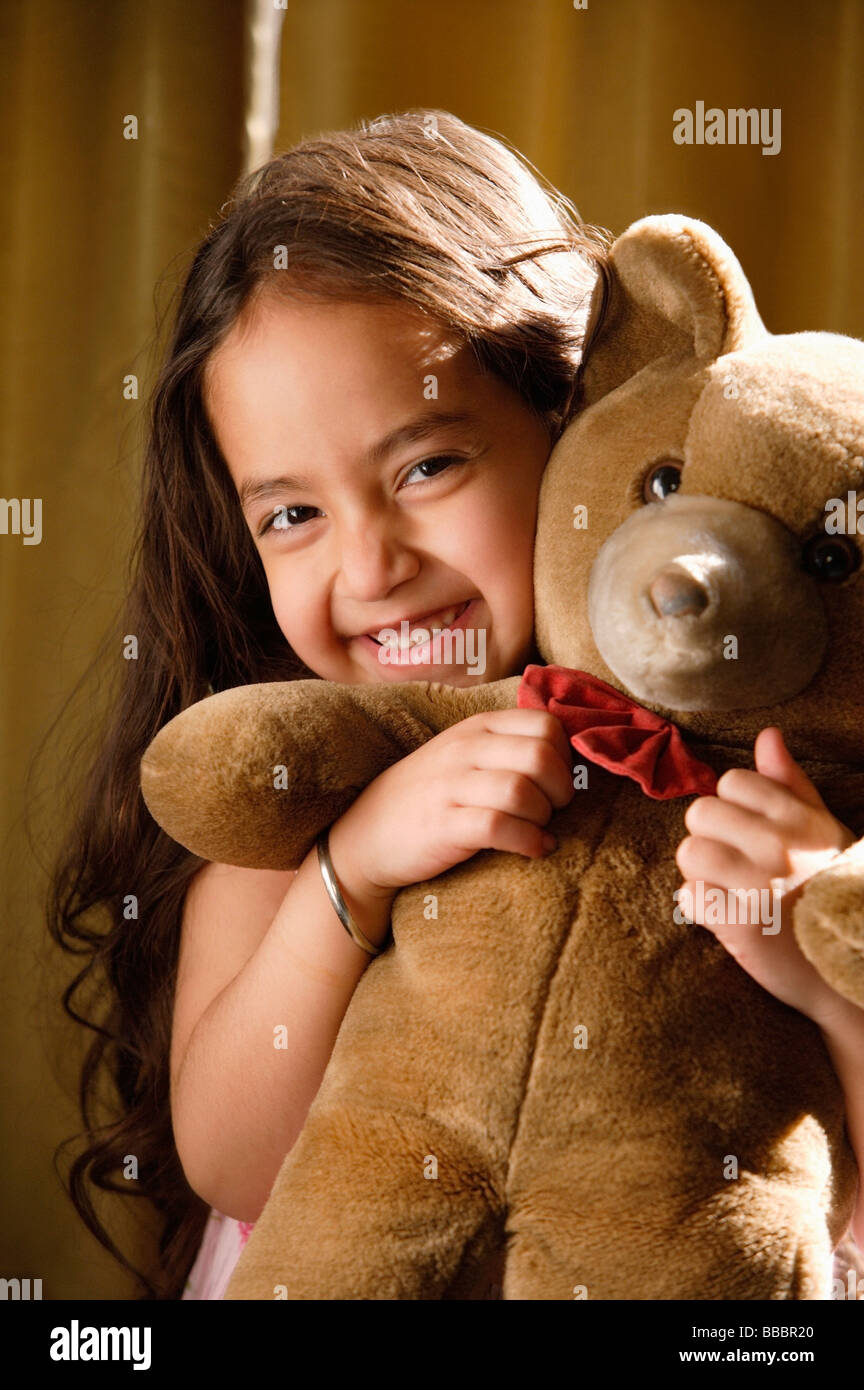 little girl hugging teddy bear Stock Photo - Alamy
