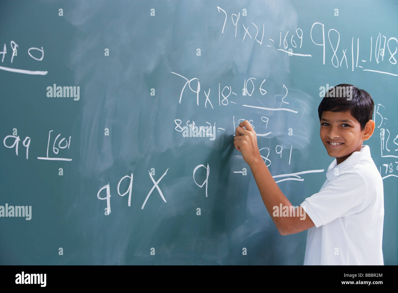 boy at chalkboard, smiling at camera Stock Photo - Alamy