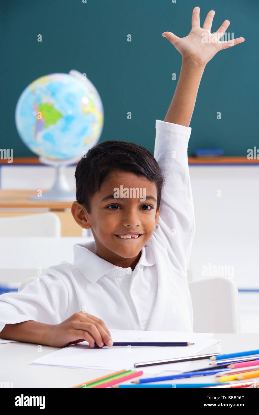 boy raises his hand excitedly Stock Photo - Alamy