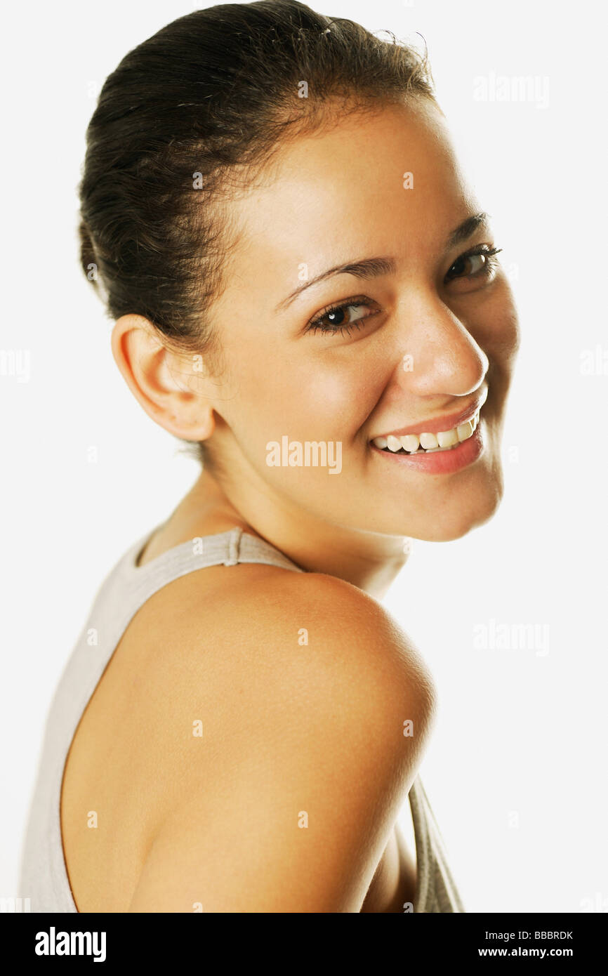 Young woman looking over shoulder at camera Stock Photo - Alamy