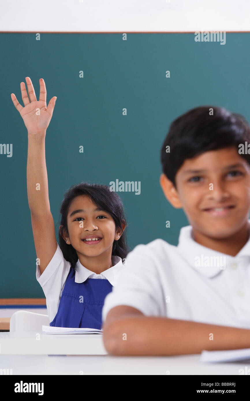 two students, girl raises hand Stock Photo - Alamy