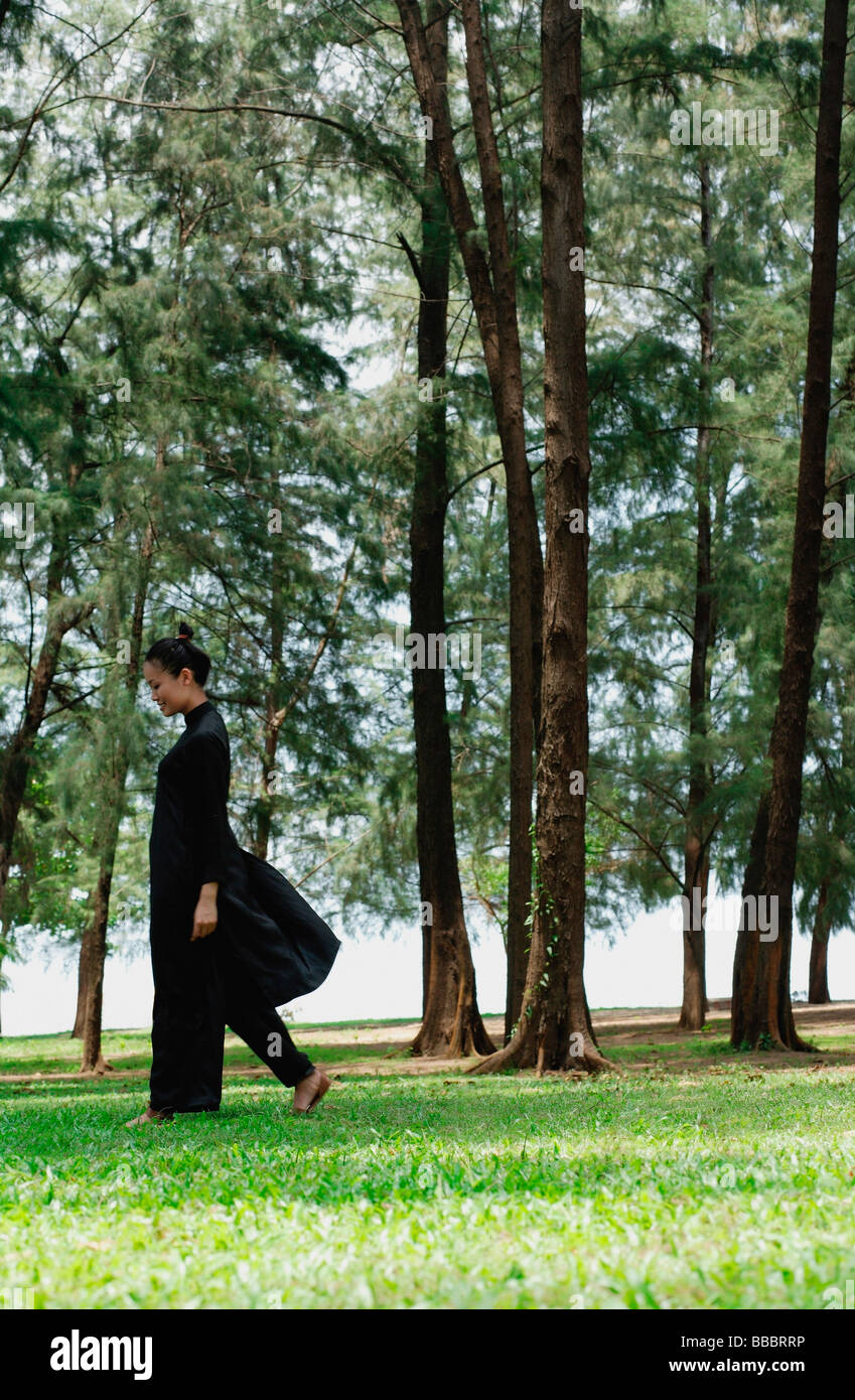 Young woman in traditional Chinese costume, walking amongst trees Stock ...