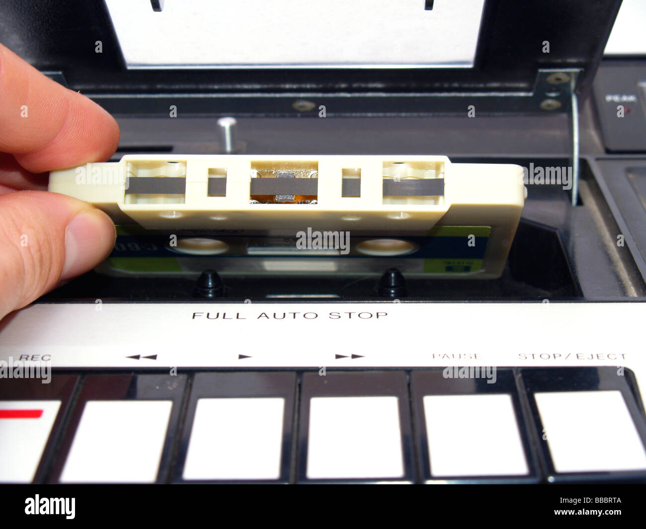 inserting old audio tape in vintage cassette recorder Stock Photo - Alamy