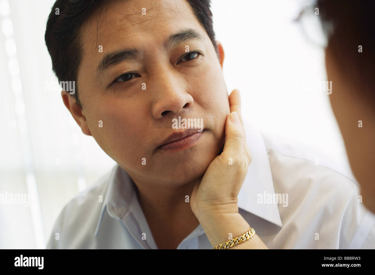 Woman touching man's face Stock Photo - Alamy