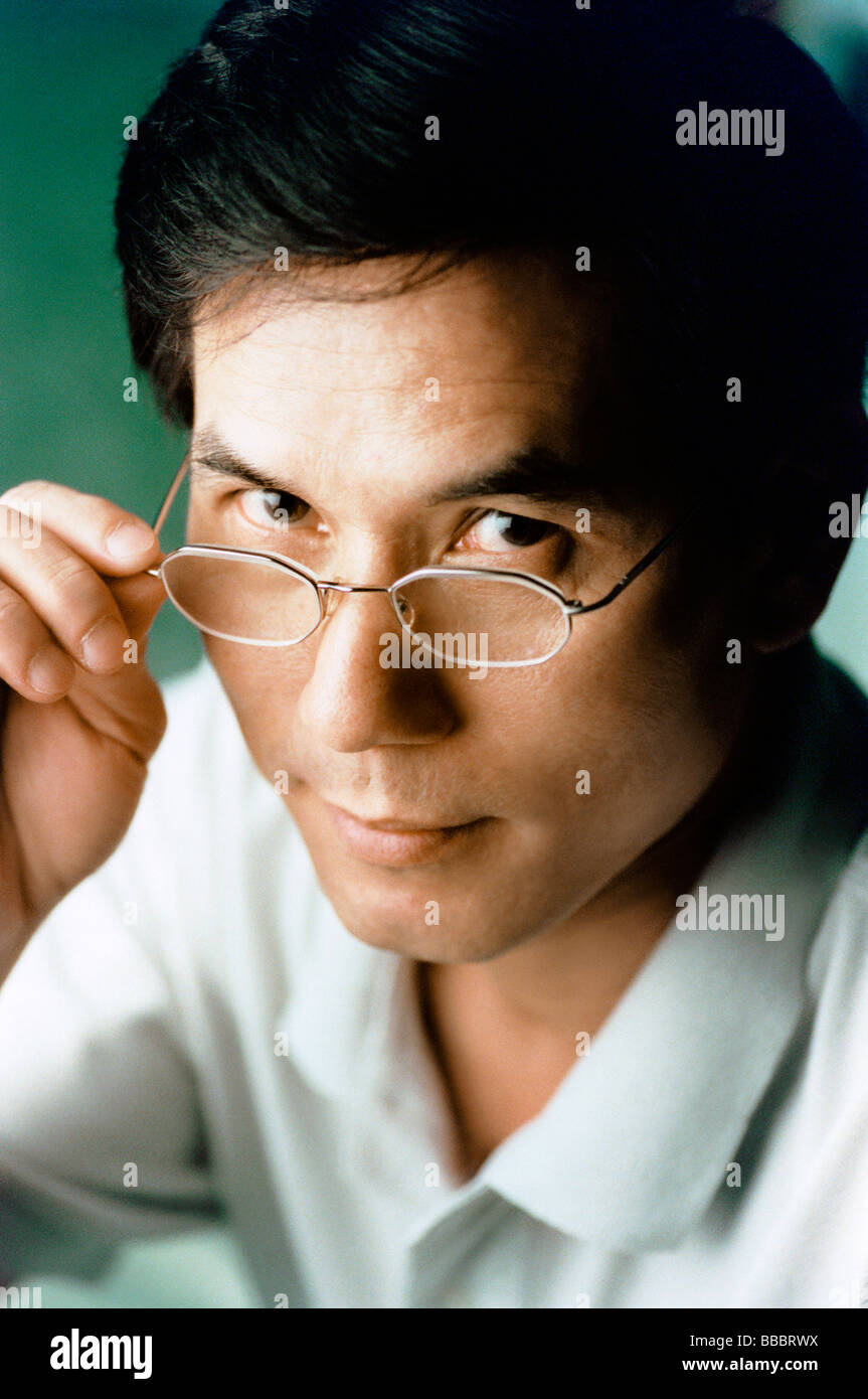 Man tipping glasses, portrait Stock Photo - Alamy