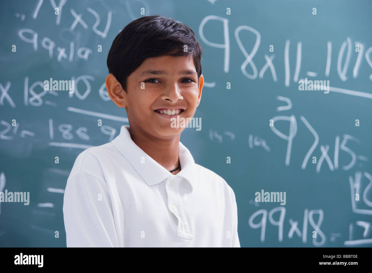 boy in front of chalkboard smiling Stock Photo - Alamy