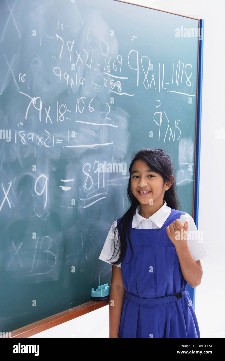 girl in front of chalkboard smiling Stock Photo - Alamy