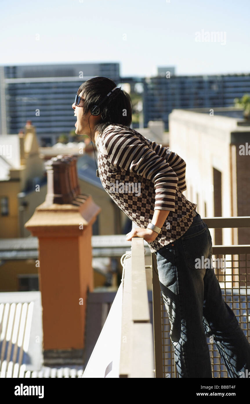 Young man leaning on railing, screaming Stock Photo - Alamy
