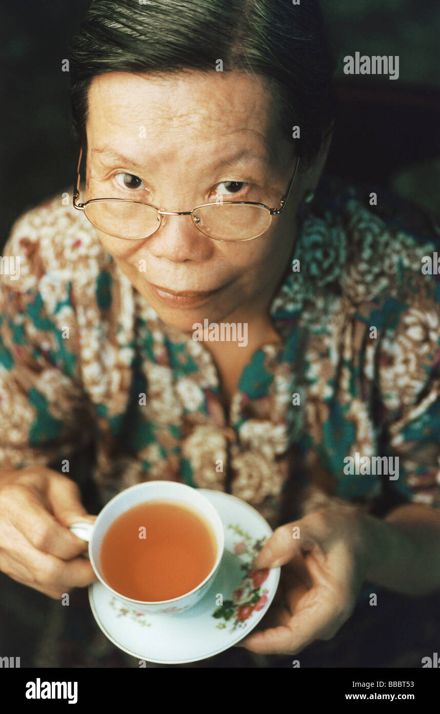 Elderly lady holding teacup and saucer, portrait Stock Photo - Alamy