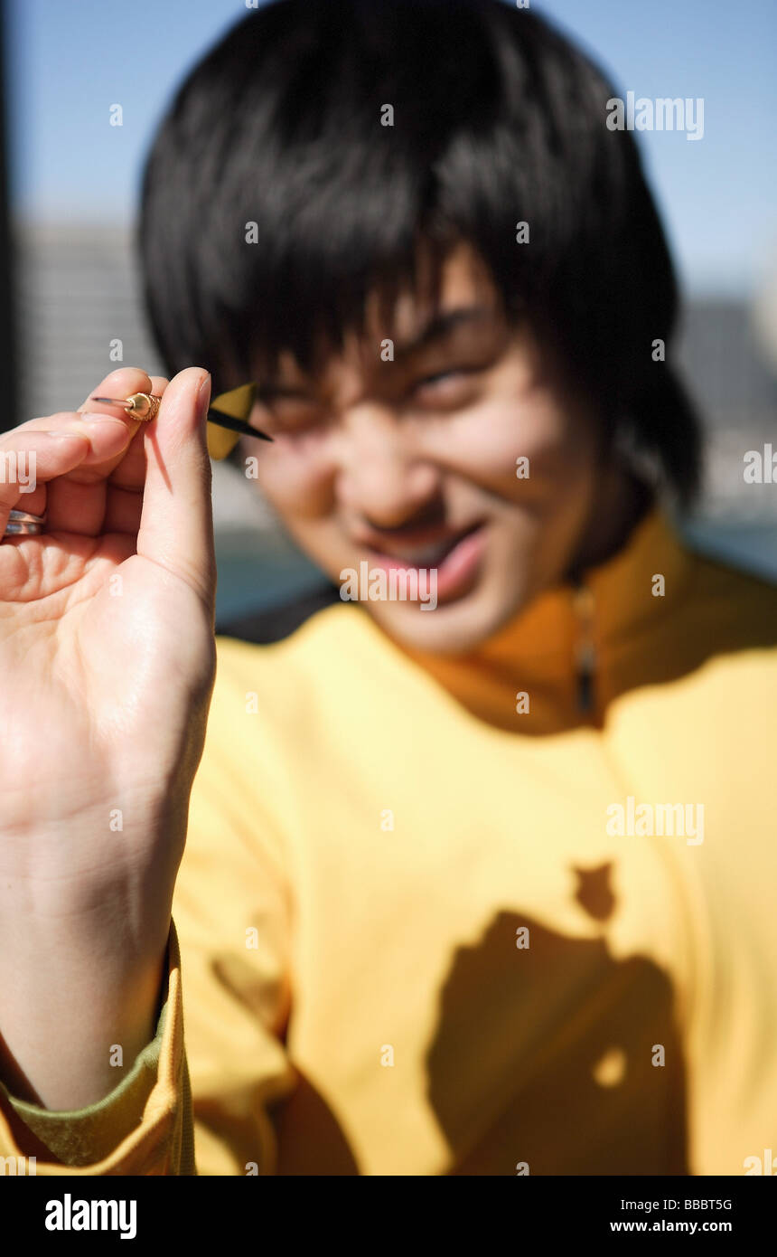Young man holding dart Stock Photo - Alamy Young man holding dart Stock Photo - Alamy