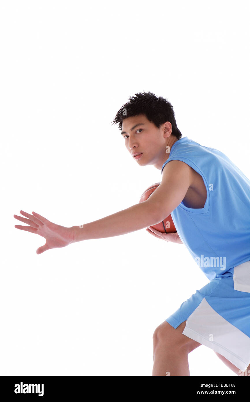 Young man playing basketball, arm outstretched Stock Photo - Alamy
