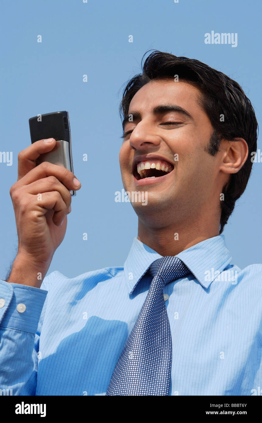 businessman reading message, laughing Stock Photo - Alamy
