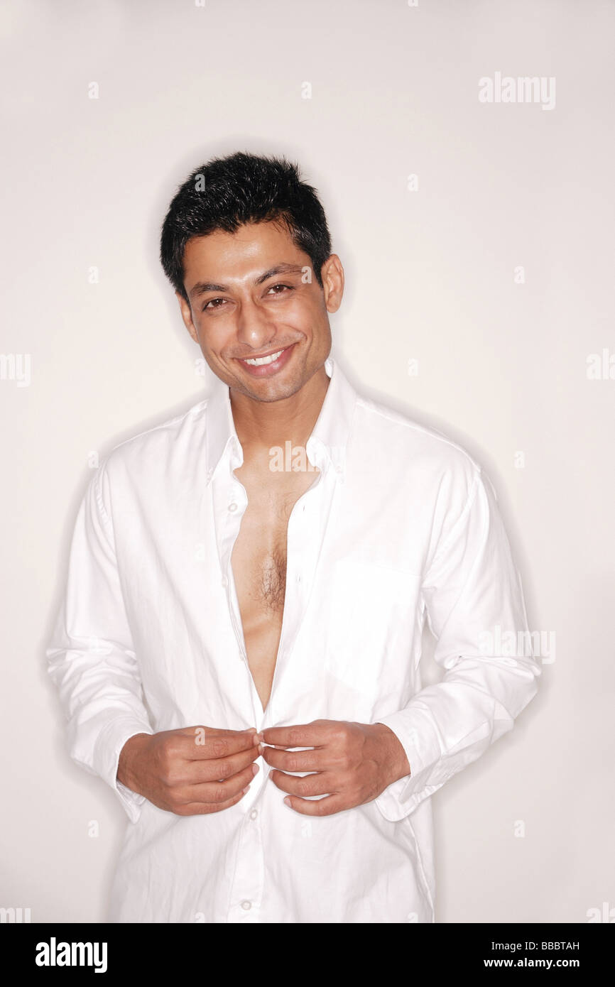 Man looking at camera, shirt partially unbuttoned Stock Photo - Alamy